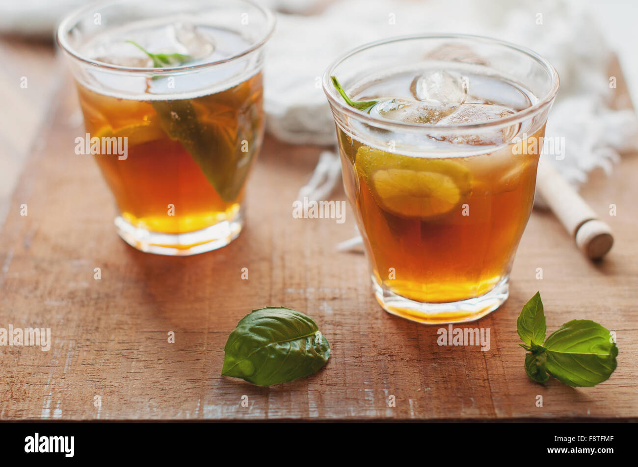 Iced Tea in transparent glass with basil , ice and lemon Stock Photo ...