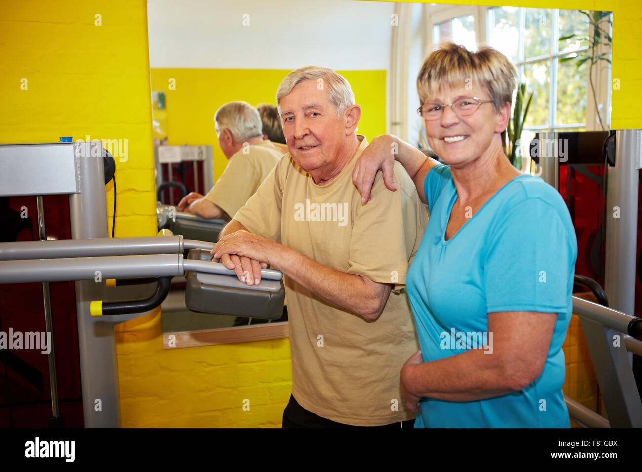Two happy senior people smiling in gym Stock Photo - Alamy