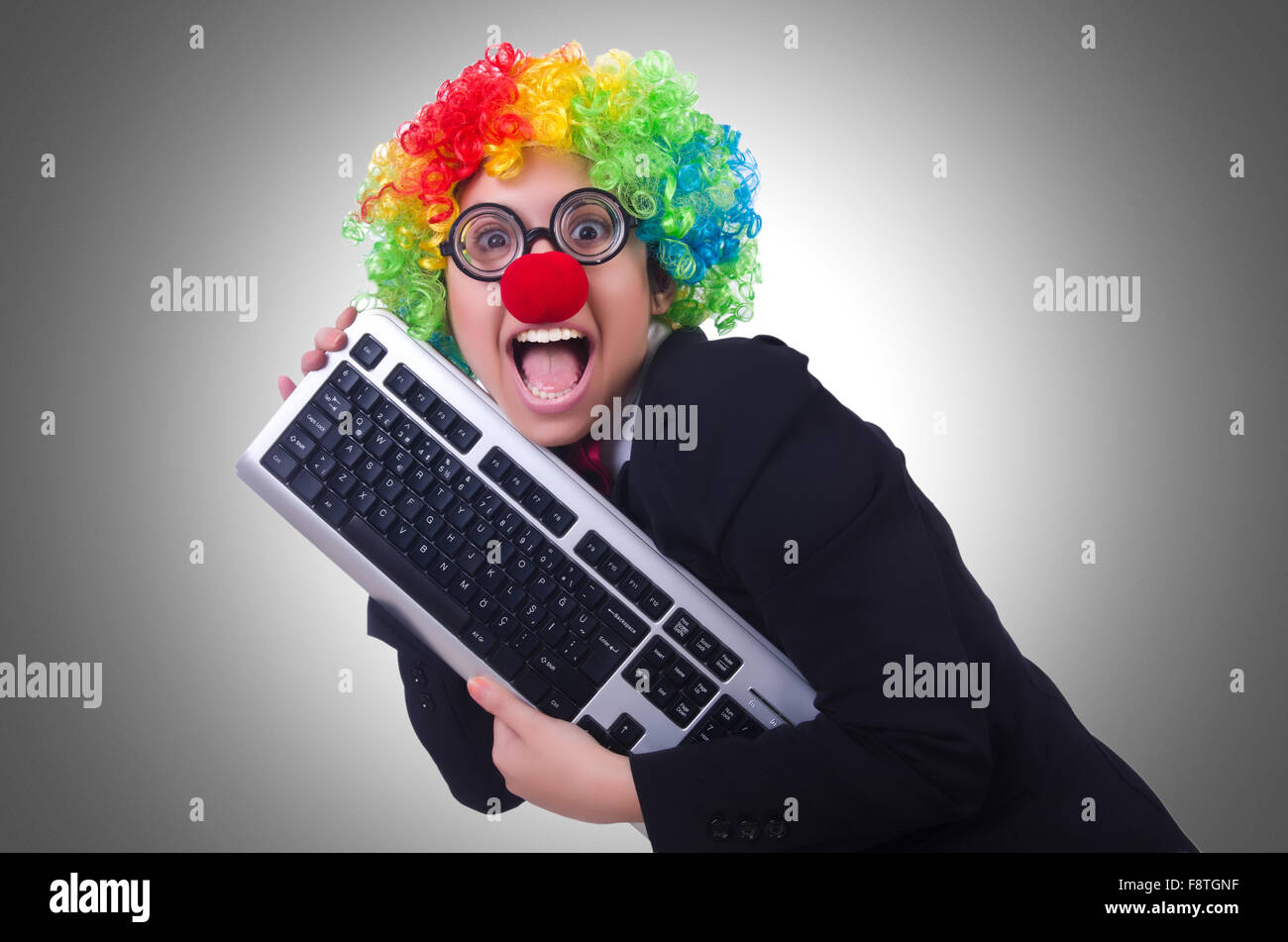 Funny clown with keyboard on white Stock Photo - Alamy