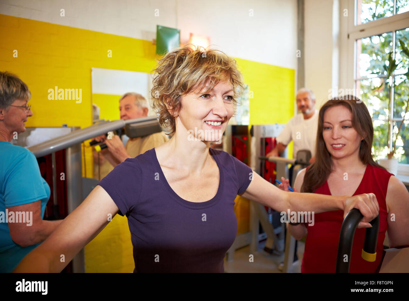 Mixed group doing circuit training in a gym Stock Photo - Alamy