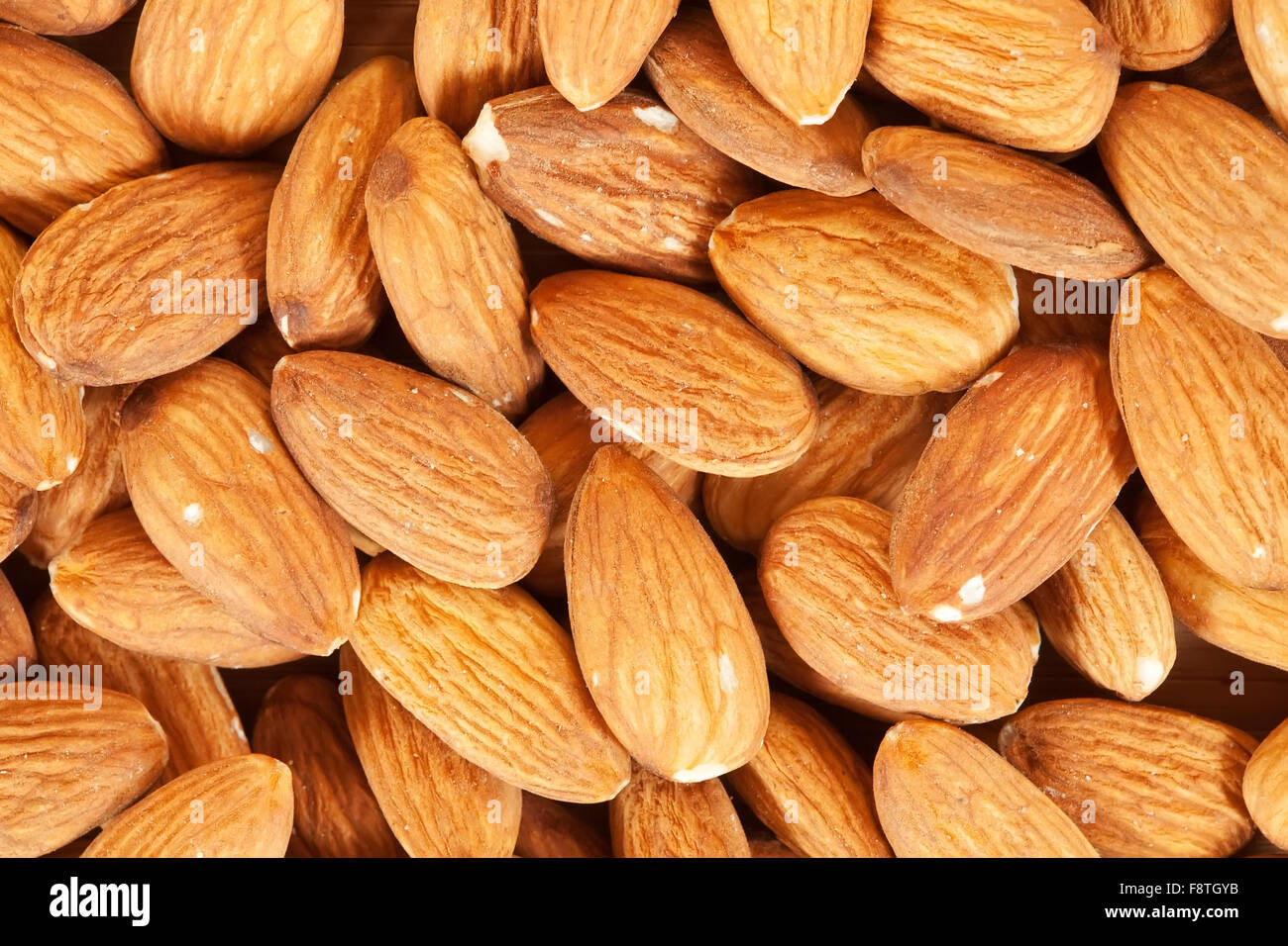 Many almond nuts, may be used as background Stock Photo - Alamy