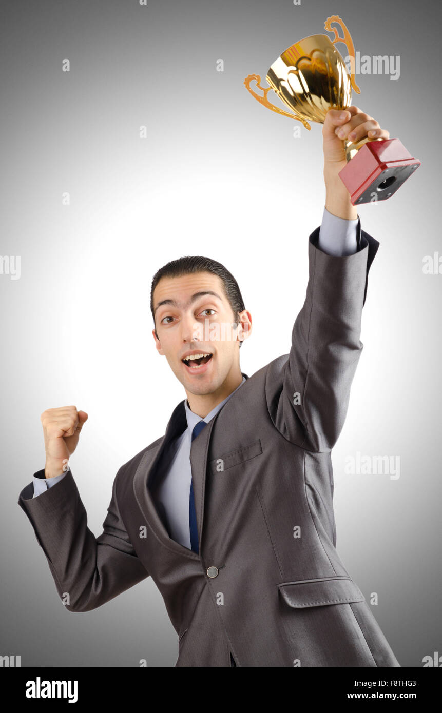 Man being awarded with golden cup Stock Photo - Alamy