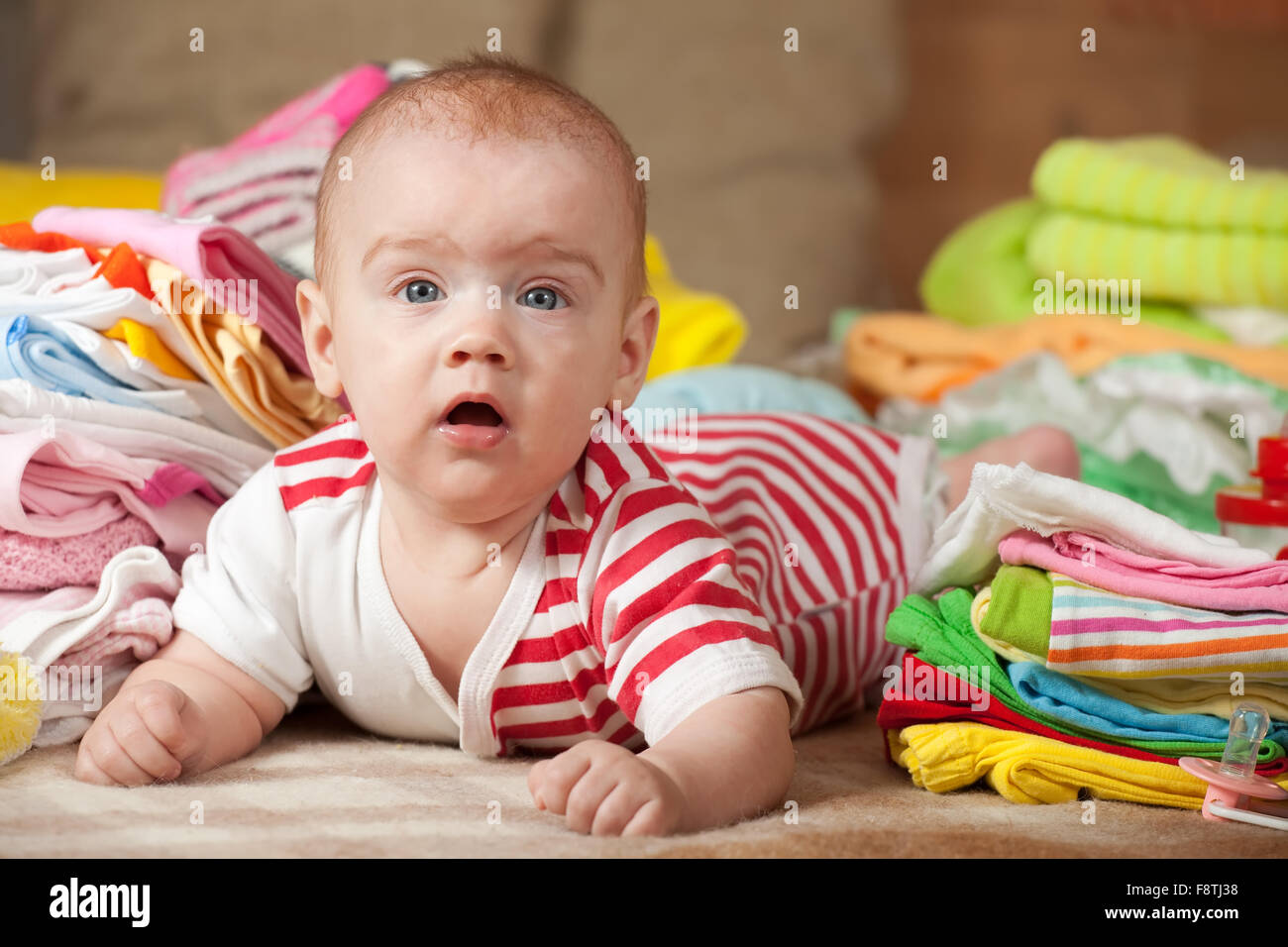 Baby Girl With Stacked Of Children s Clothes Stock Photo Alamy baby-girl-with-stacked-of-children-s-clothes-stock-photo-alamy