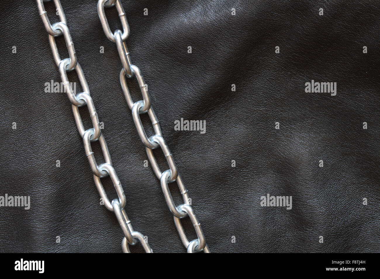 Chain On Leather Stock Photo - Alamy