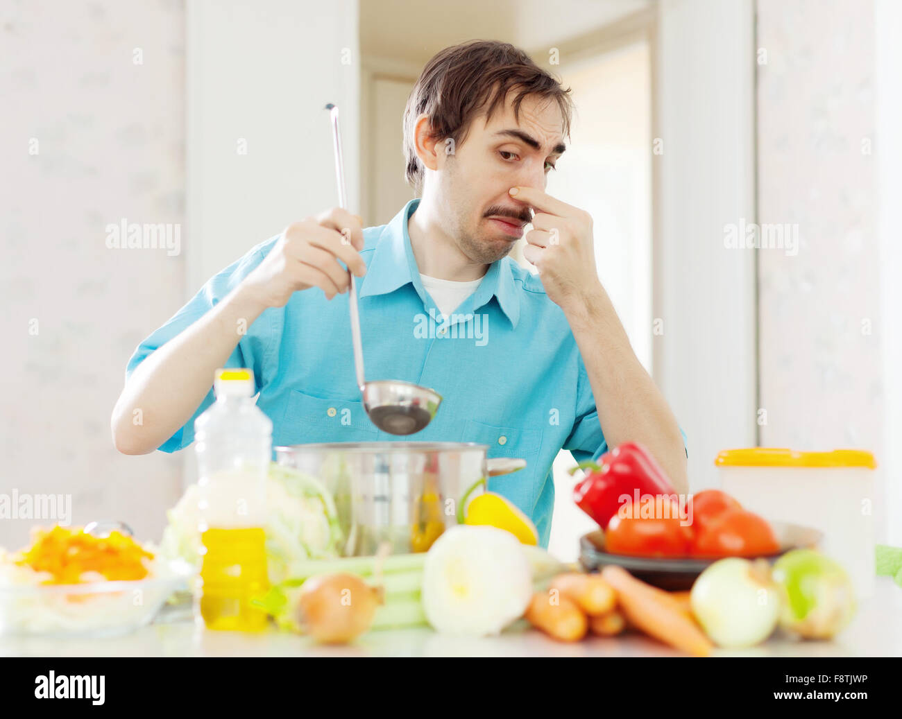 Man with foul food at kitchen Stock Photo - Alamy