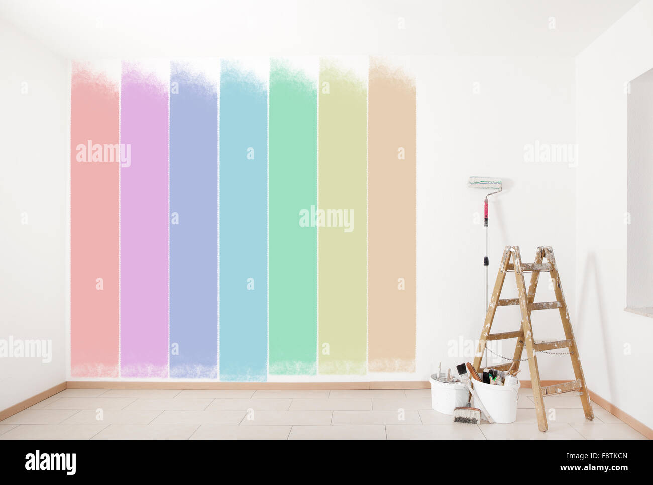 a choice of bright colors on a wall with ladder and painting tools ...