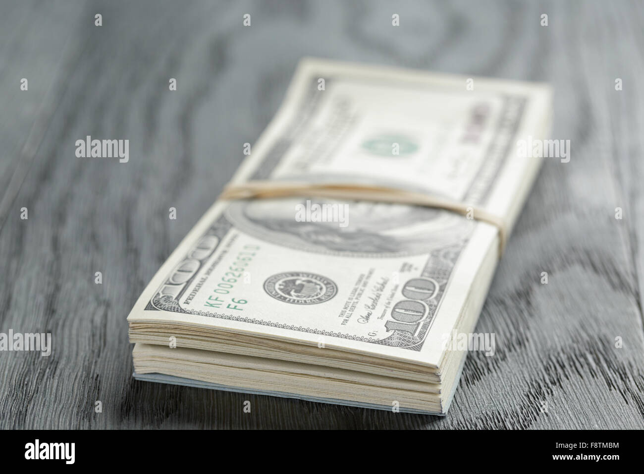 bunch of hundred dollar notes tied with rubberband Stock Photo - Alamy
