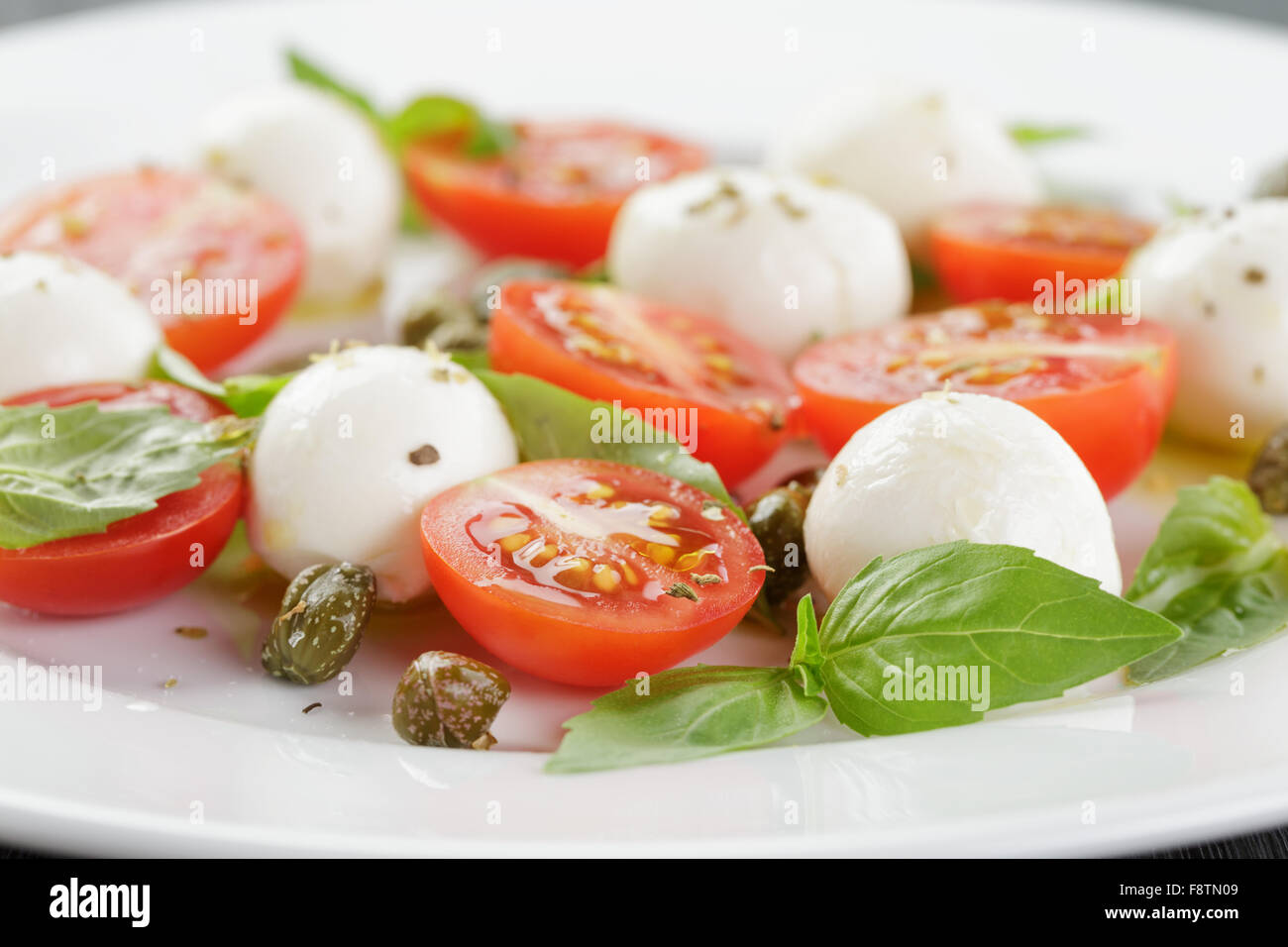 caprese salad with mini mozzarella balls and tomatoes Stock Photo - Alamy