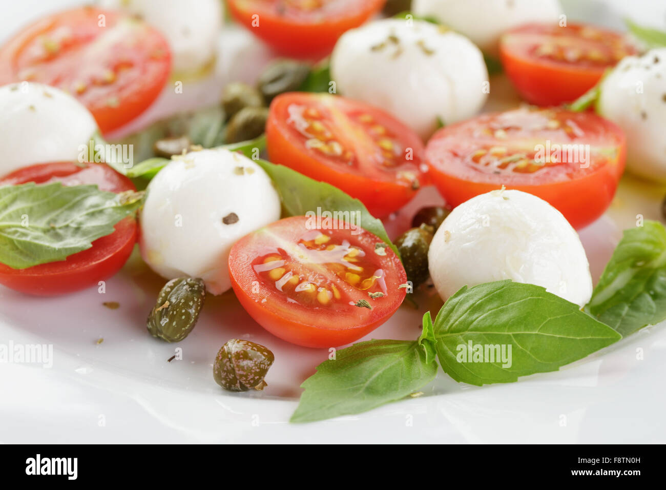 caprese salad with mini mozzarella balls and tomatoes Stock Photo - Alamy