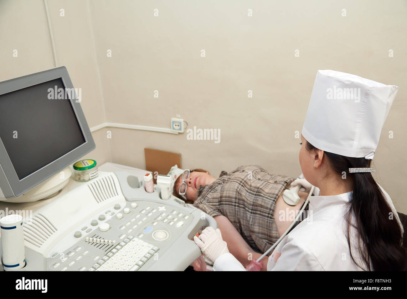 Female doctor making ultrasound investigation in medical clinic Stock ...