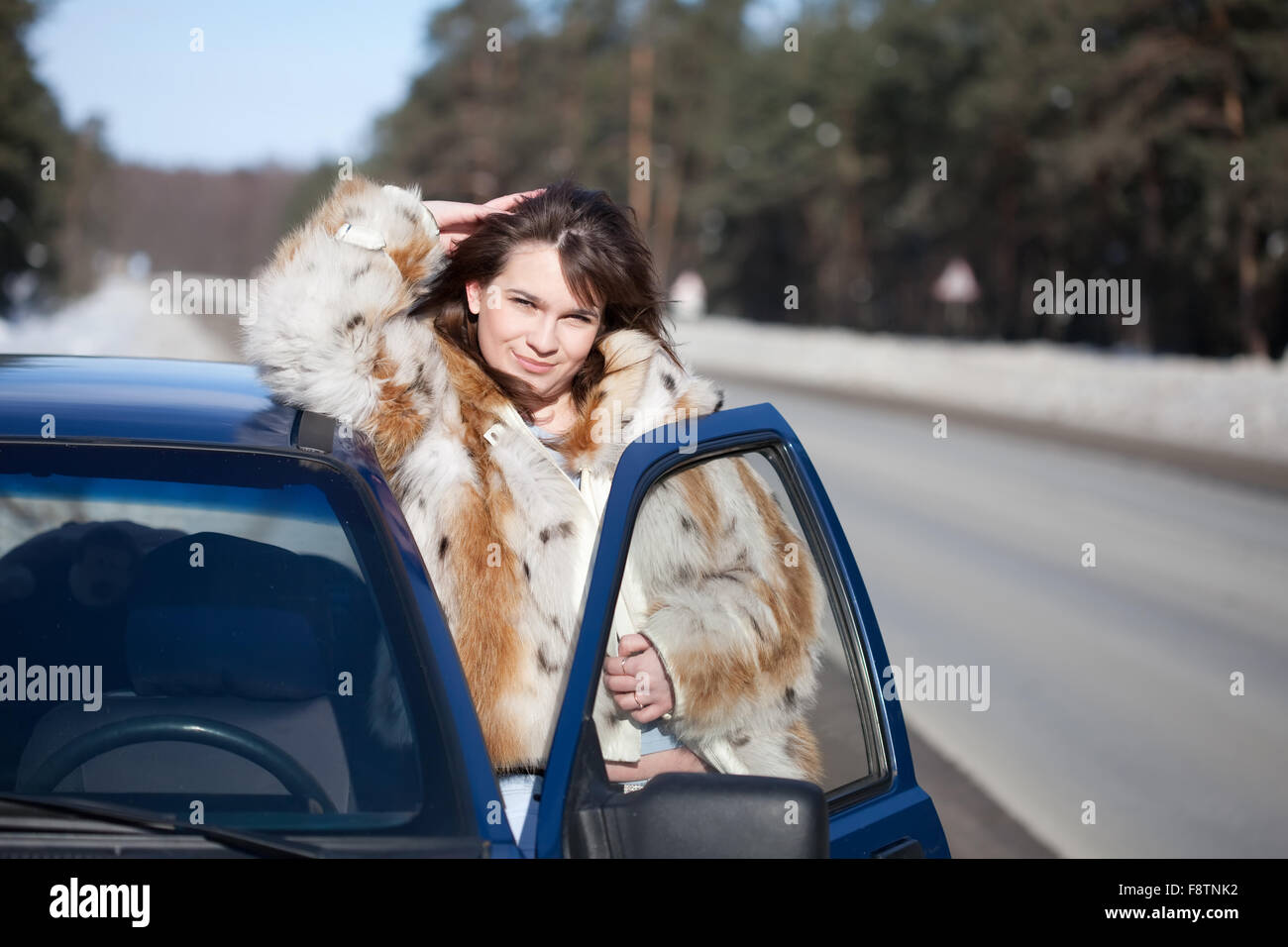 Young woman with her car in winter day Stock Photo - Alamy