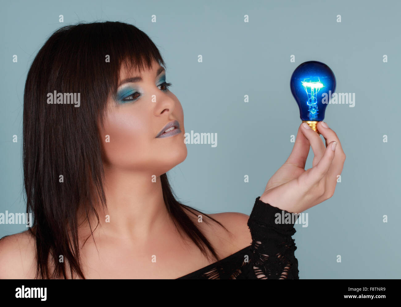 woman holding light bulb Stock Photo - Alamy