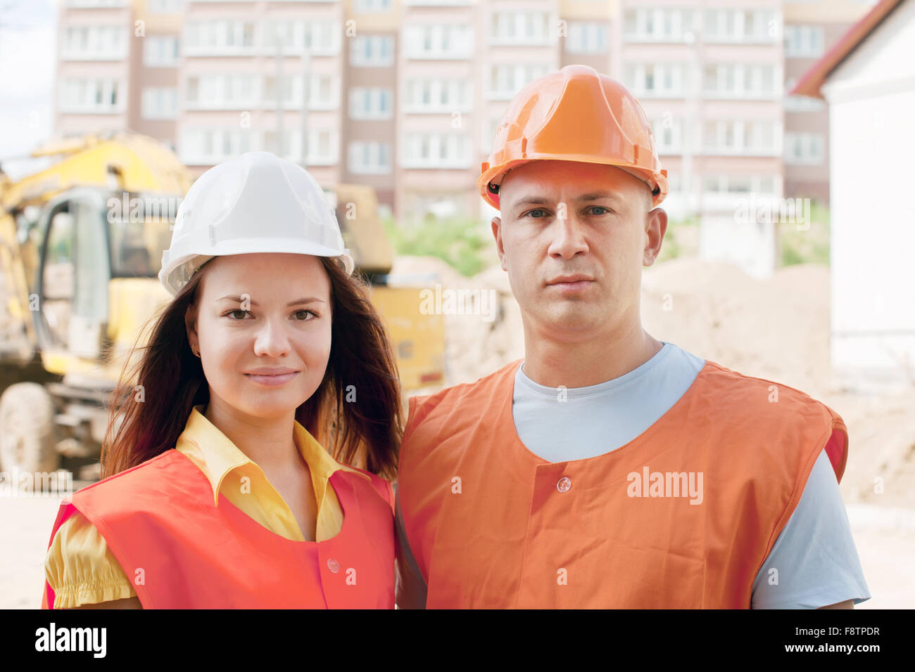 Portrait of two builders works at construction site Stock Photo - Alamy