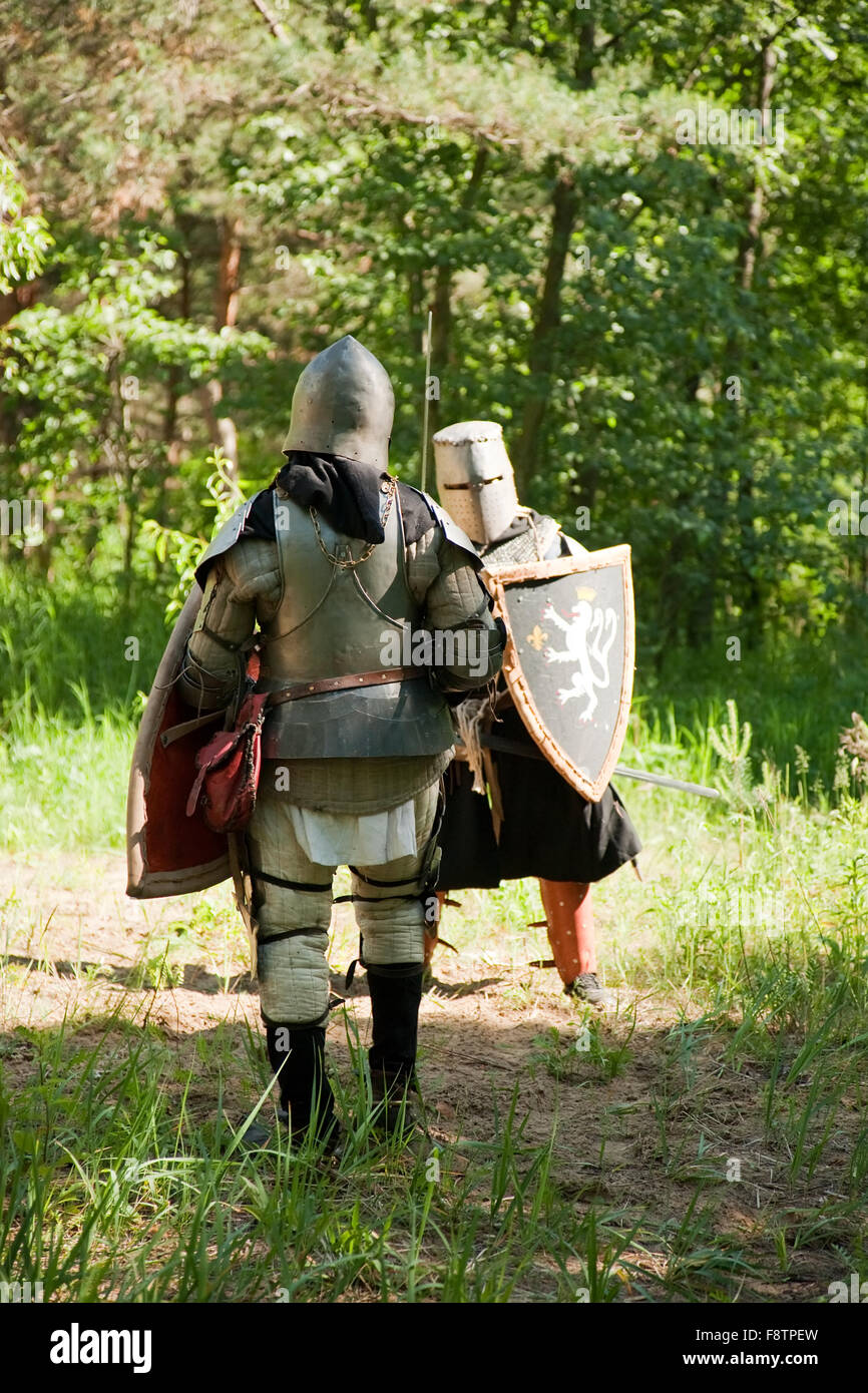 Two knights in armor is fighting at forest Stock Photo - Alamy