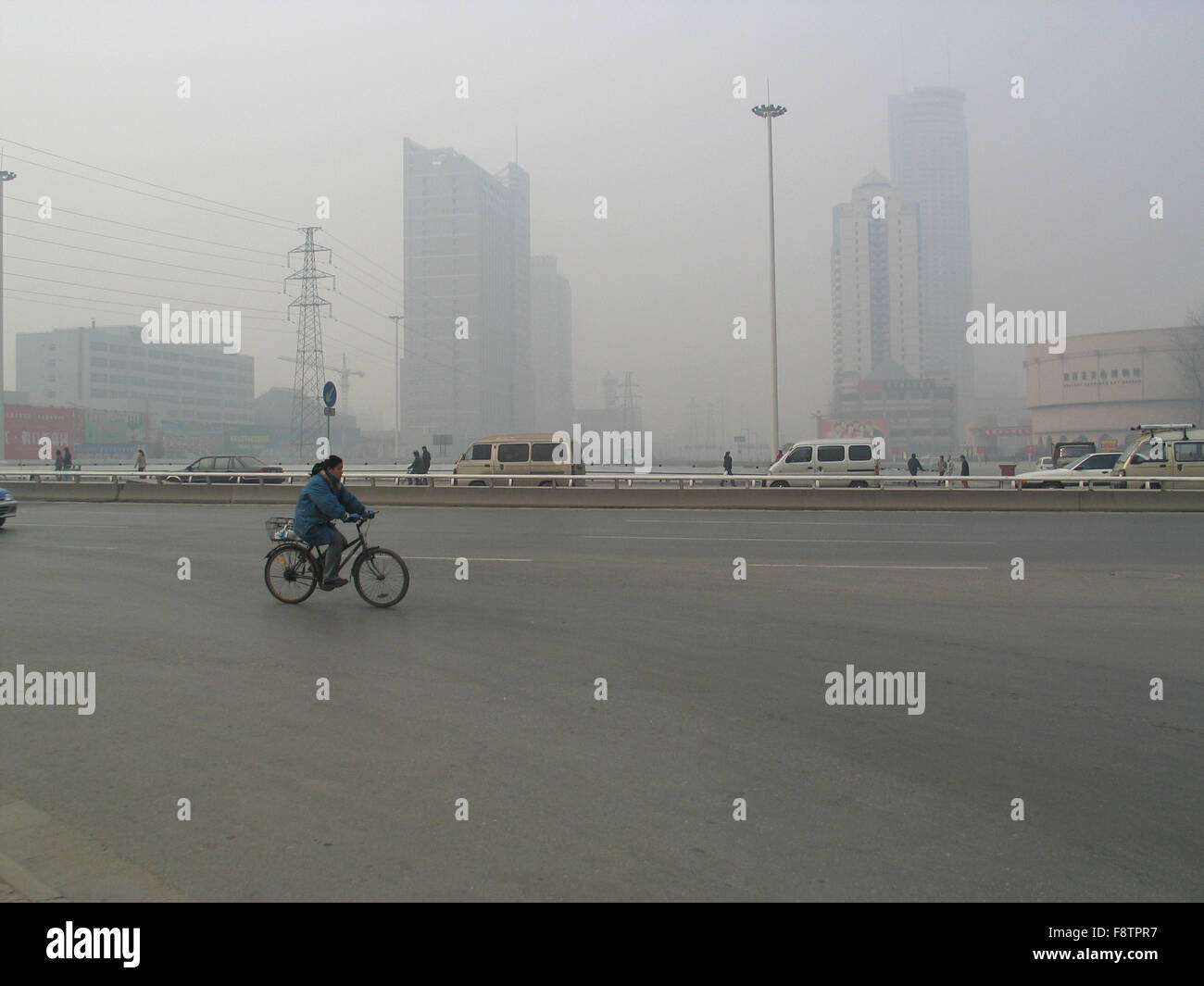 Cyclist in city smog Stock Photo - Alamy
