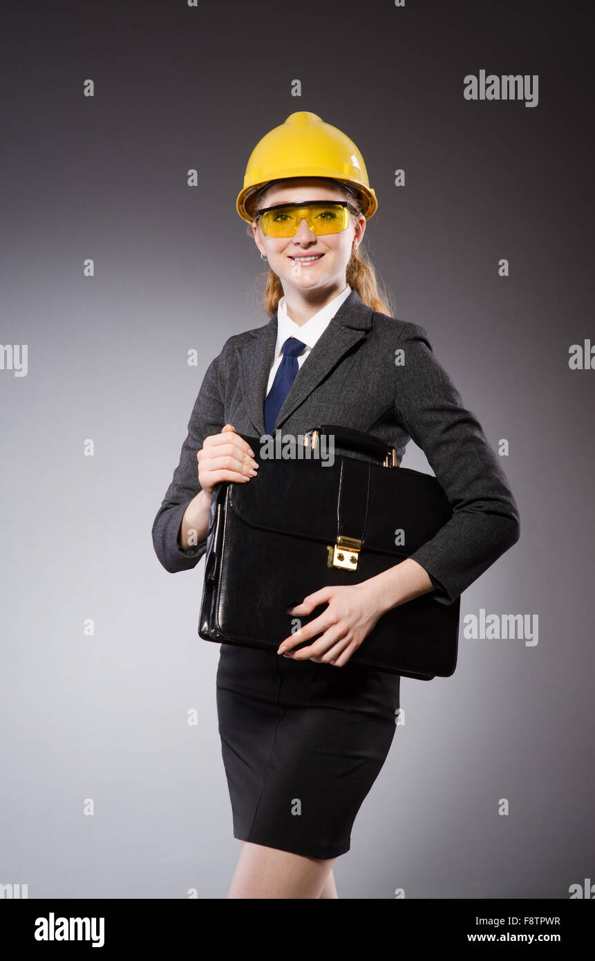 Female engineer with helmet isolated on gray Stock Photo - Alamy