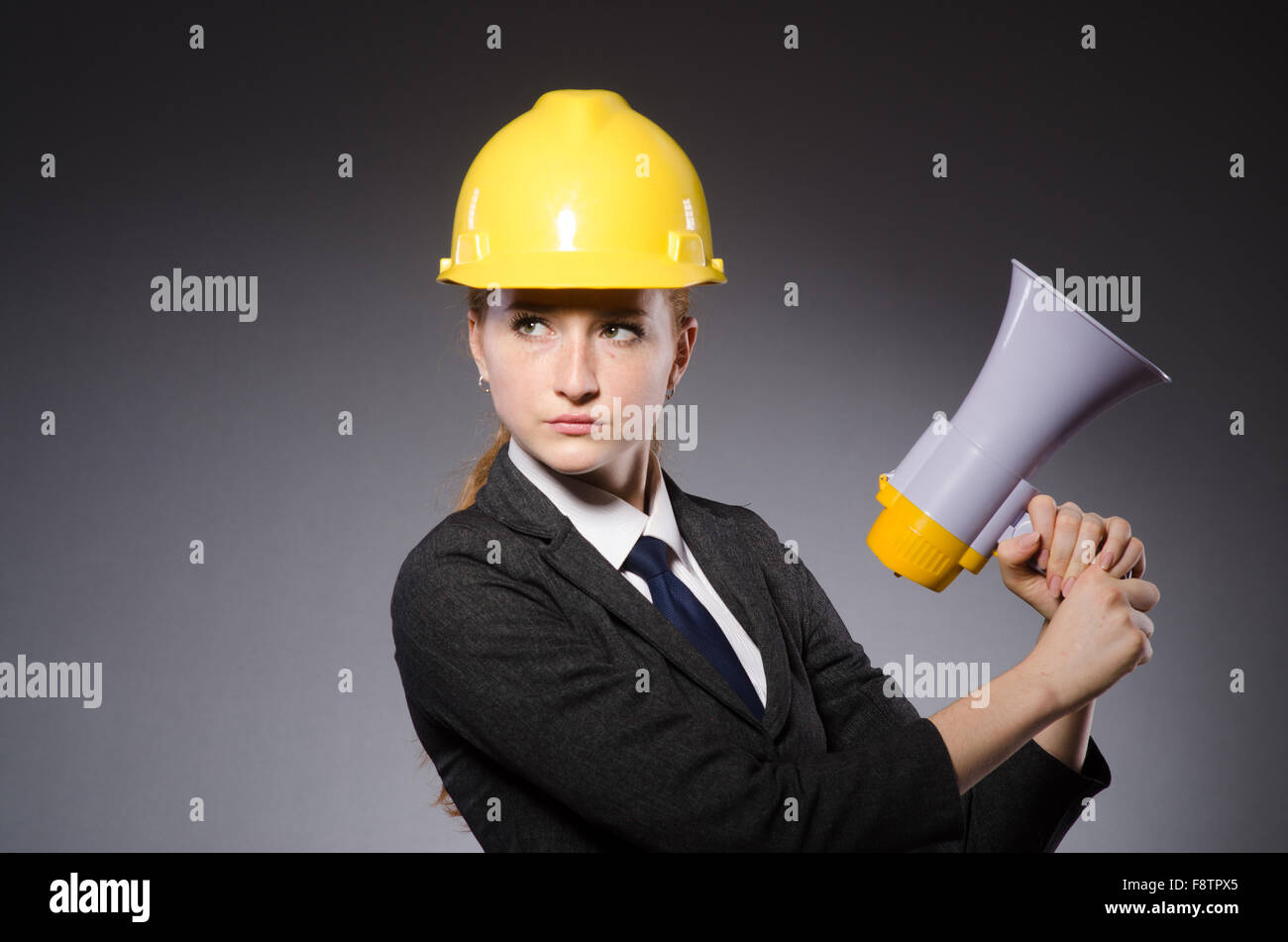 Female engineer with helmet isolated on gray Stock Photo - Alamy