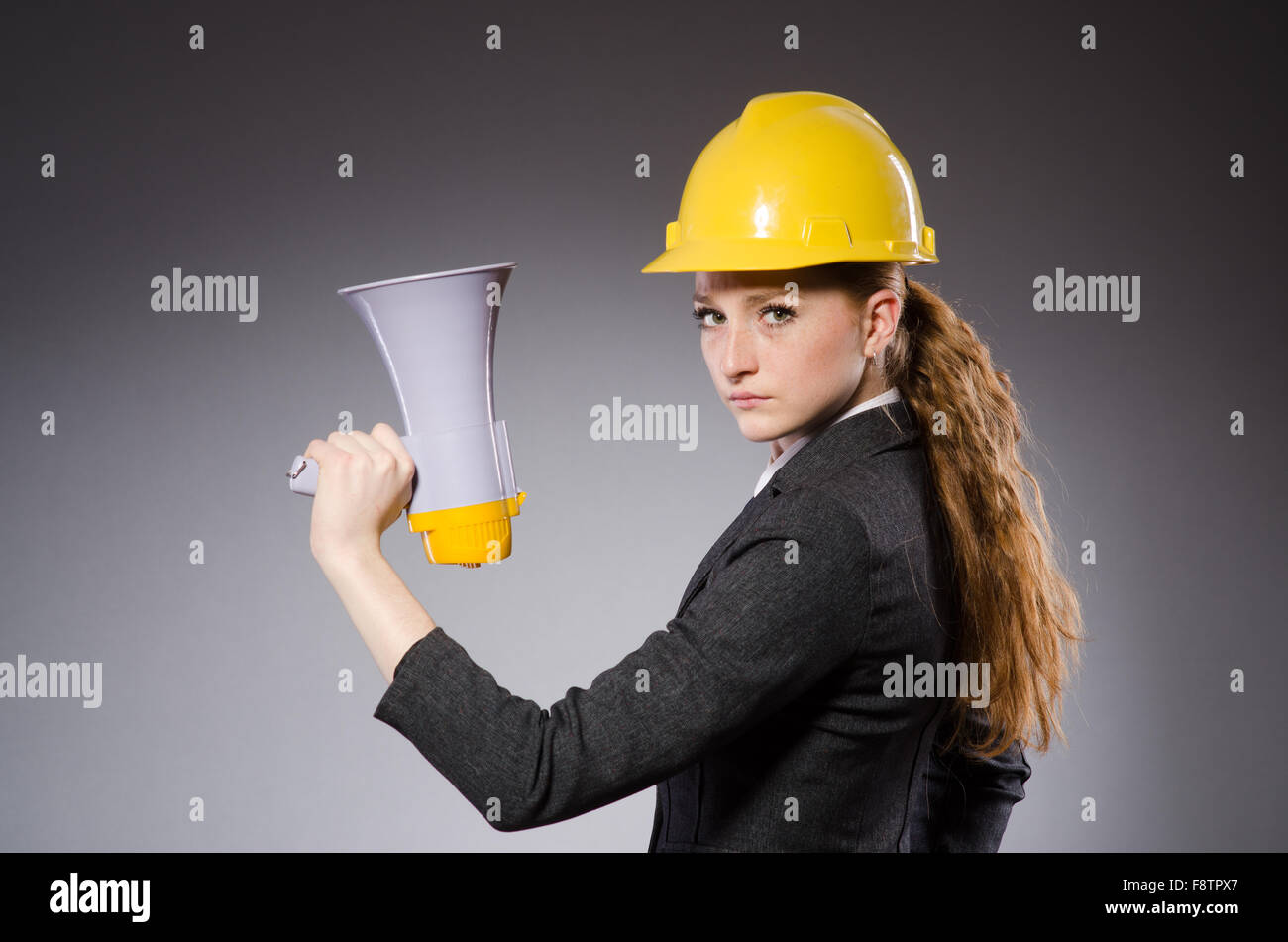Female engineer with helmet isolated on gray Stock Photo - Alamy