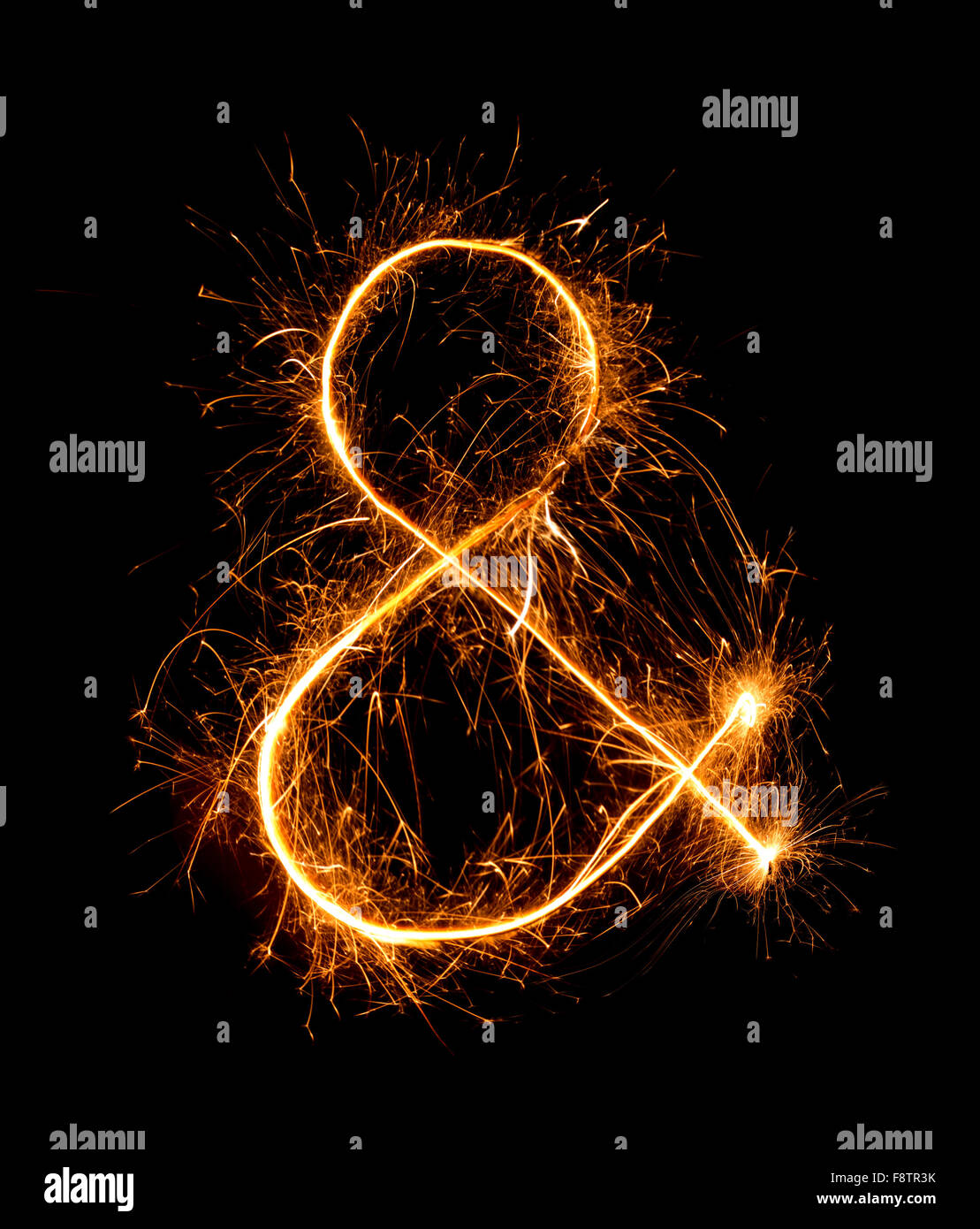 ampersand symbol made of firework sparklers at night background Stock ...