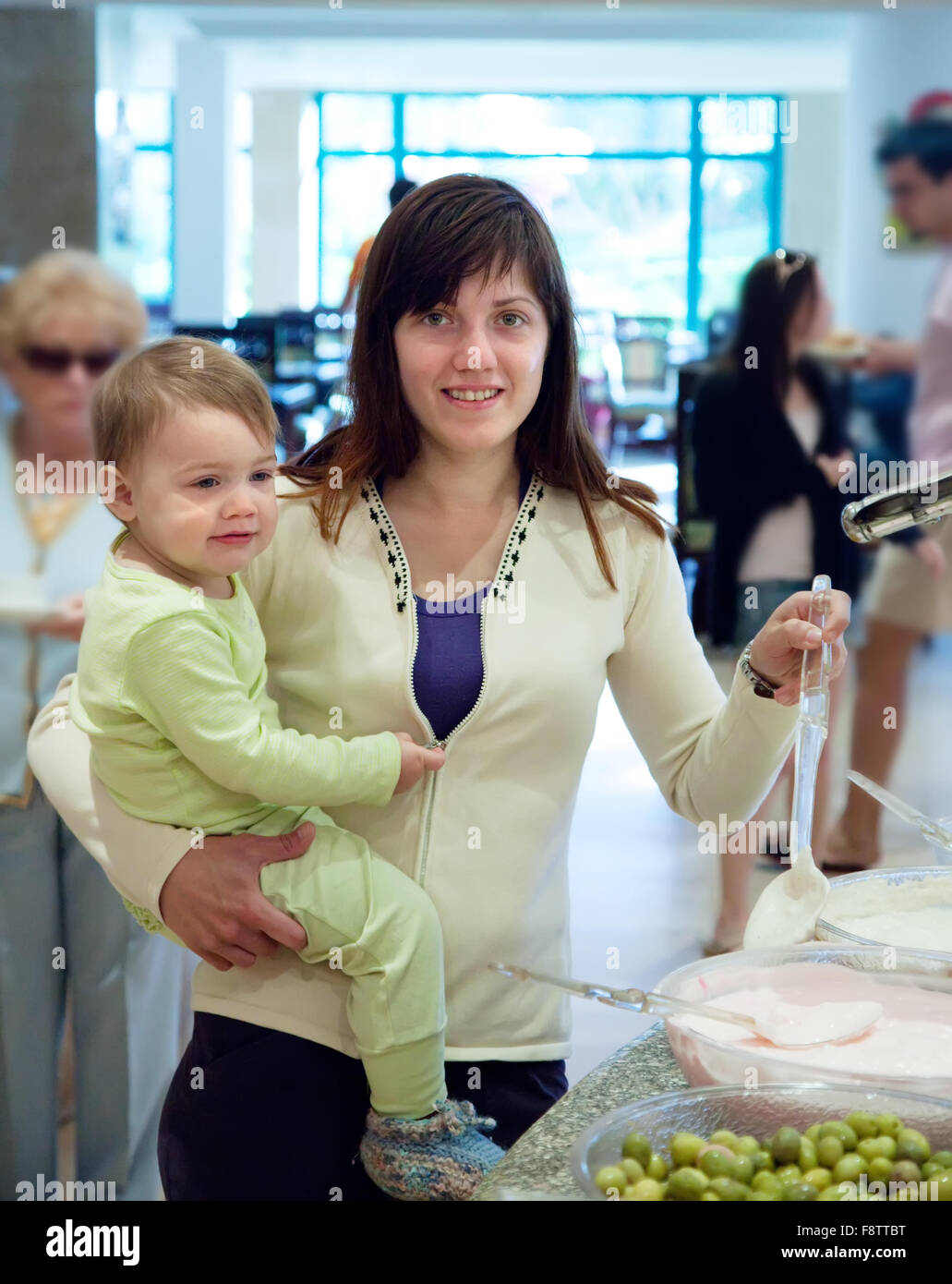 Mother with child takes milk food in hotel buffet Stock Photo - Alamy