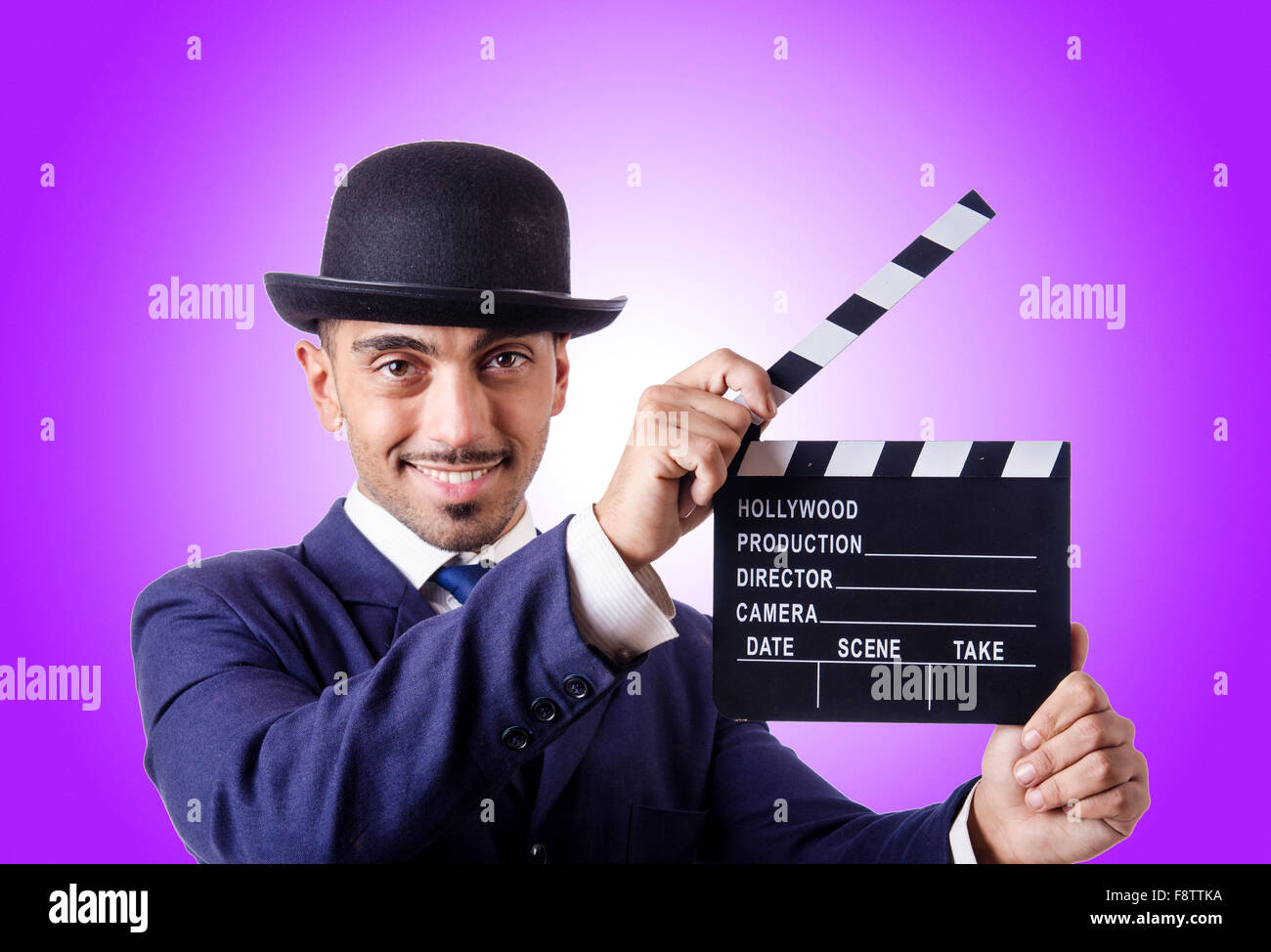 Man with movie clapper against the gradient Stock Photo - Alamy