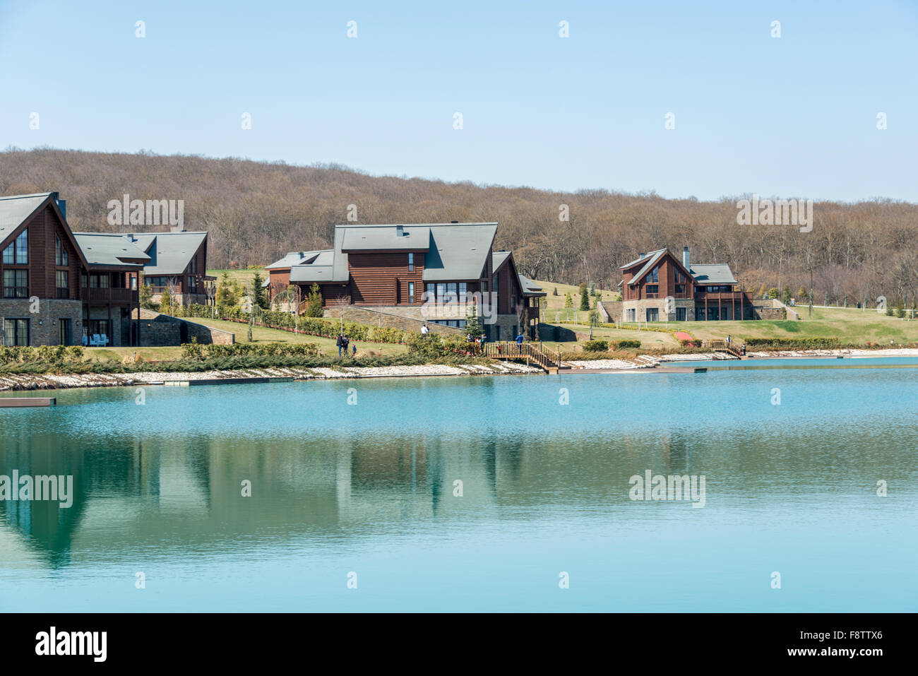 Modern house near water on bright day Stock Photo - Alamy