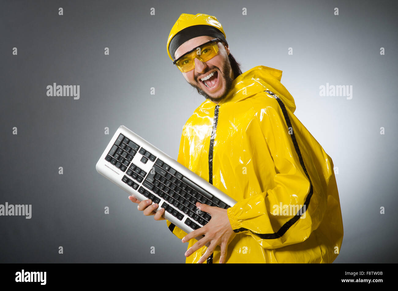 Man wearing yellow suit with keyboard Stock Photo - Alamy