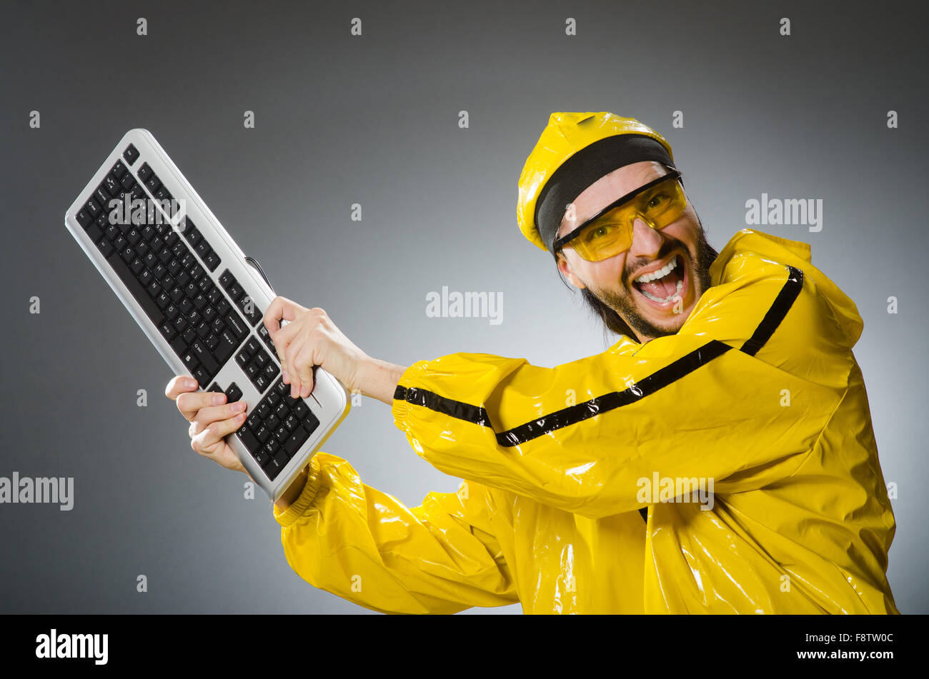 Man wearing yellow suit with keyboard Stock Photo - Alamy