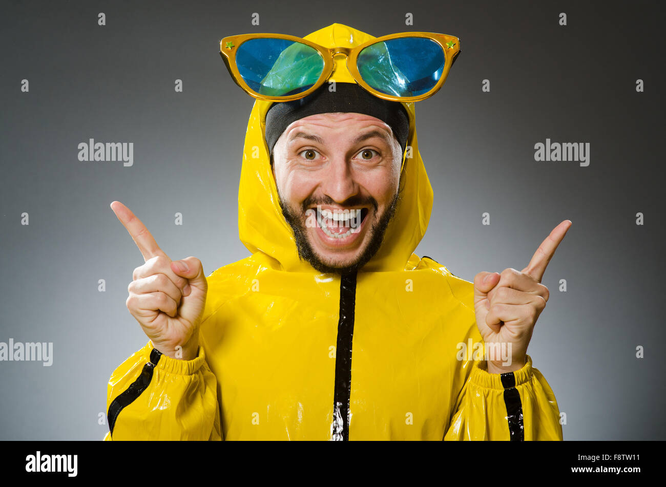 Man wearing yellow suit in funny concept Stock Photo - Alamy