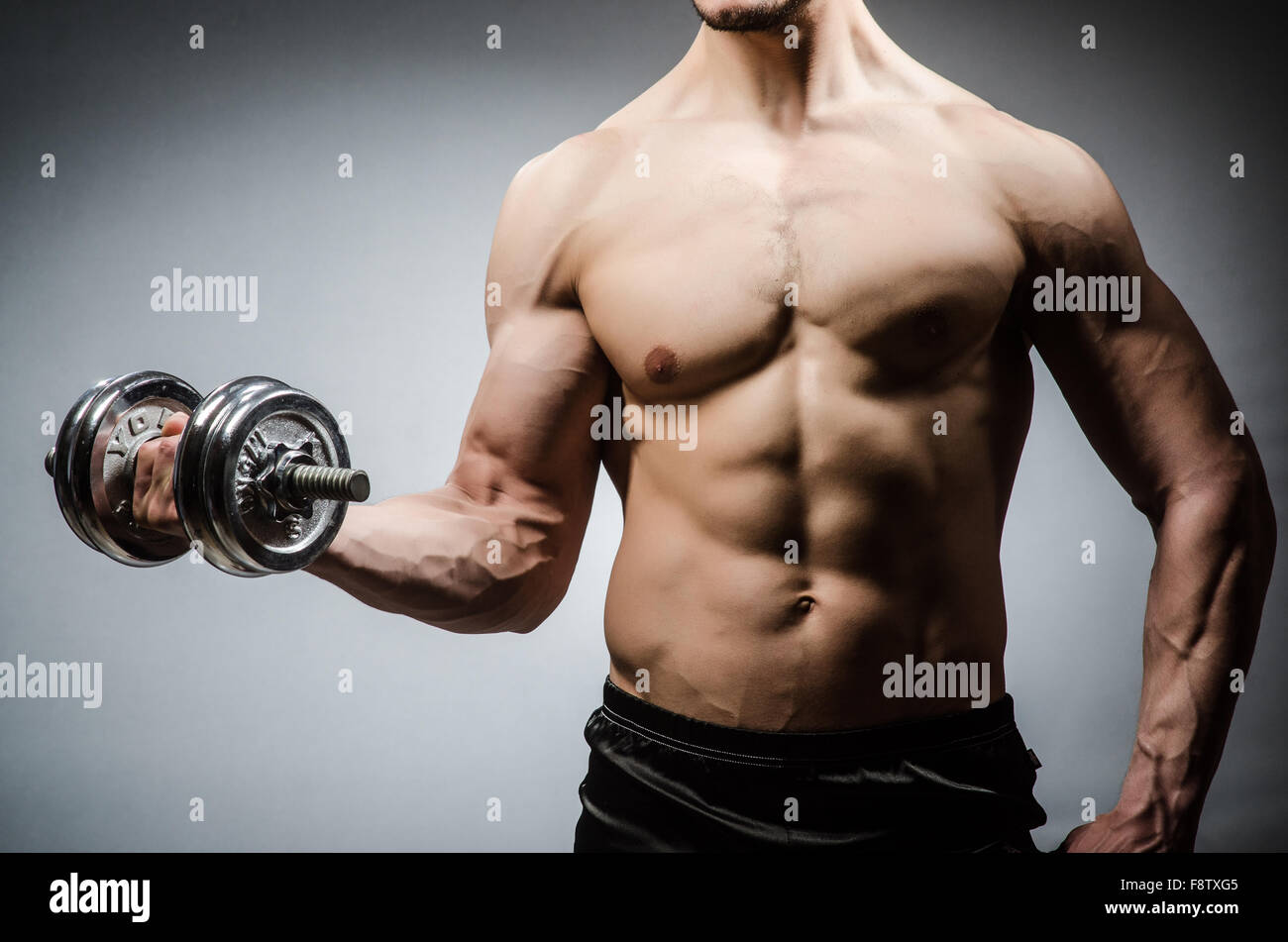 Muscular ripped bodybuilder with dumbbells Stock Photo - Alamy