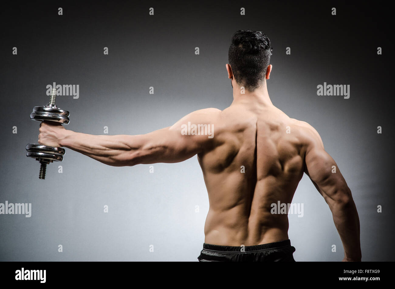 Muscular ripped bodybuilder with dumbbells Stock Photo - Alamy