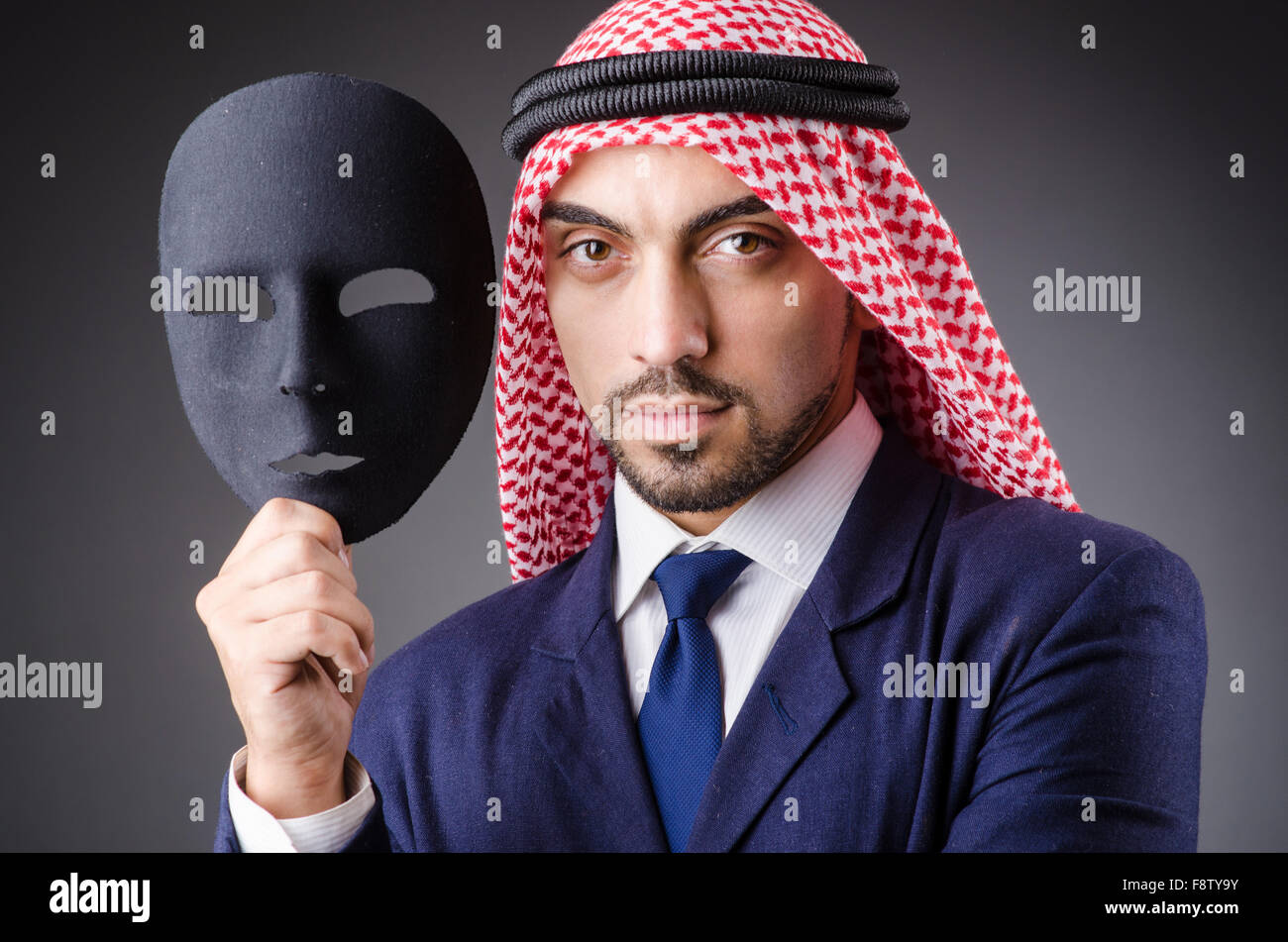Arab with masks in dark studio Stock Photo - Alamy