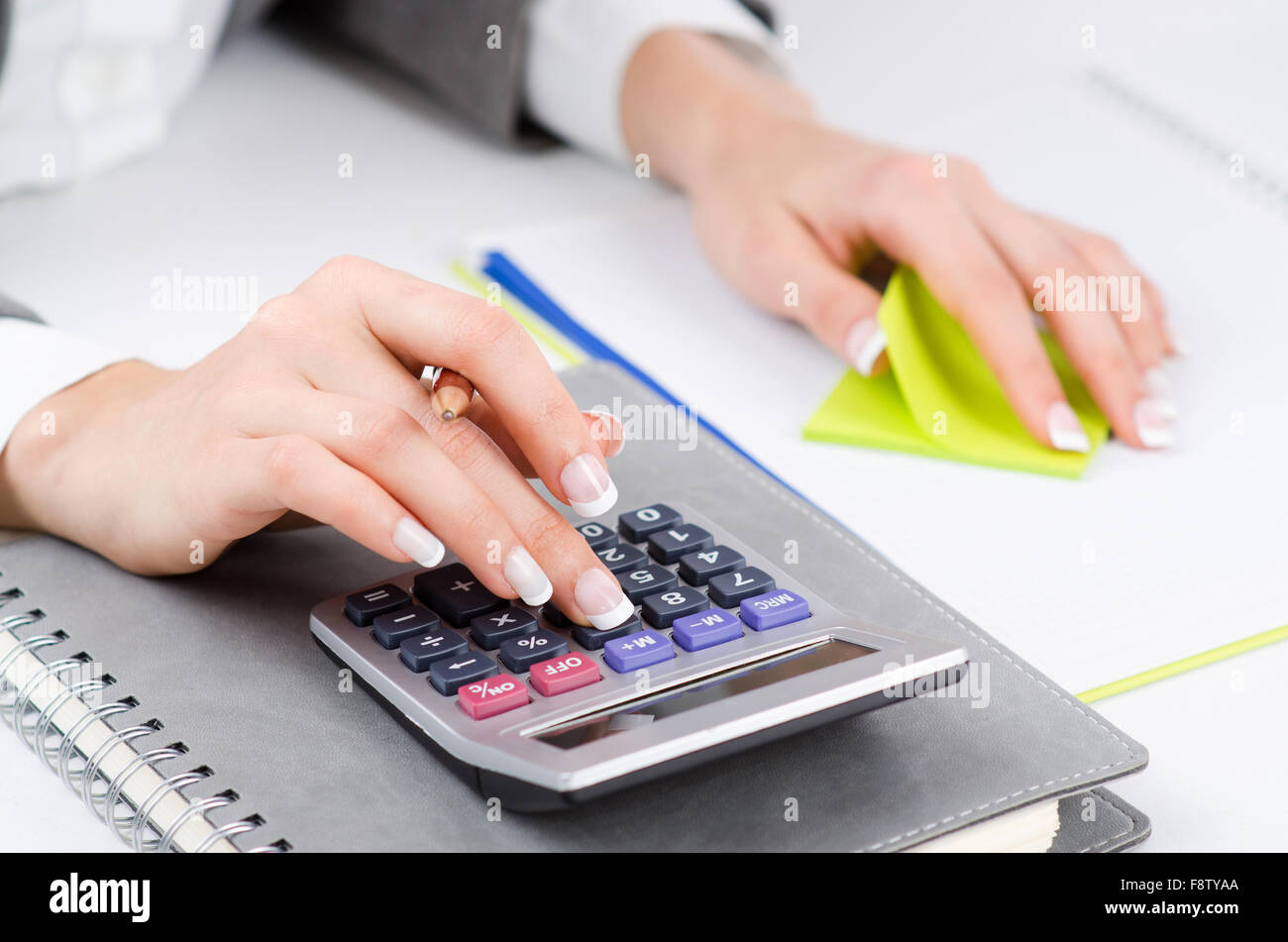Hands working on the calculator Stock Photo - Alamy