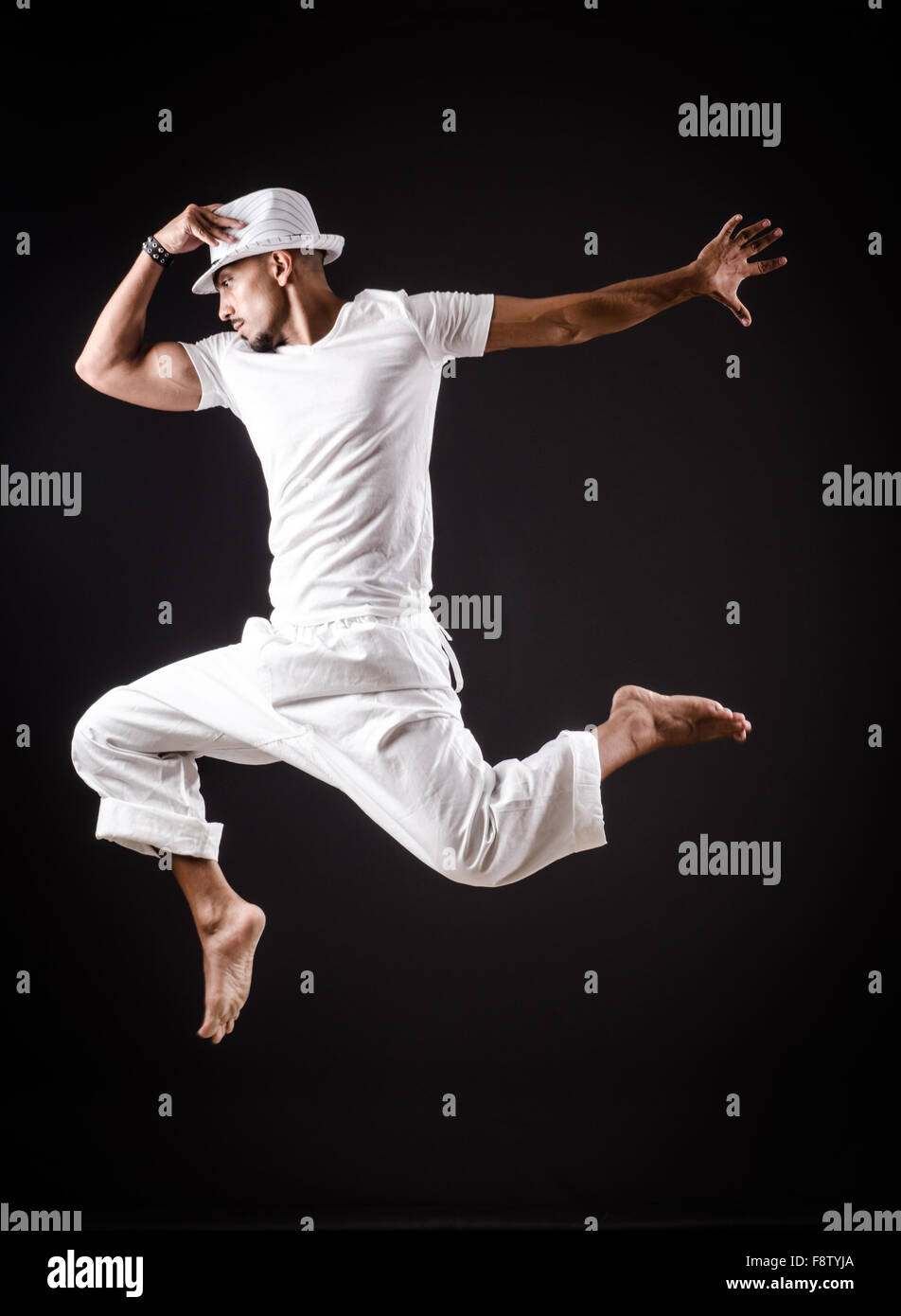 Dancer dancing dances in white clothing Stock Photo - Alamy