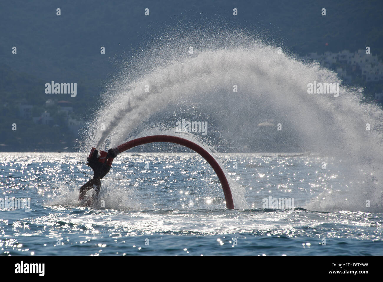 Flyboarder ankles entering water during semi-circular dive Stock Photo ...