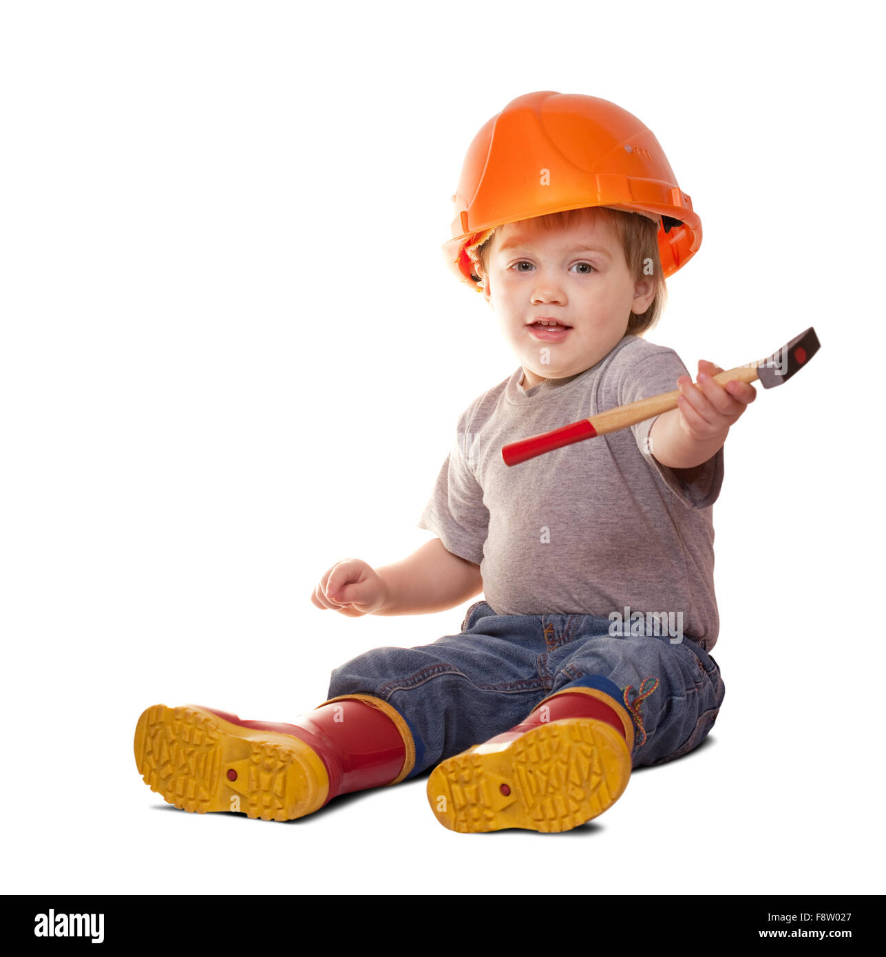 Toddler in hardhat with hammer. Isolated over white background with ...