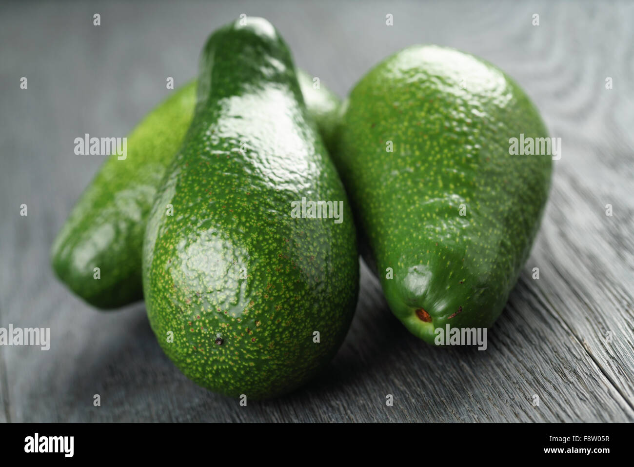 ripe green avocados on wood table Stock Photo - Alamy