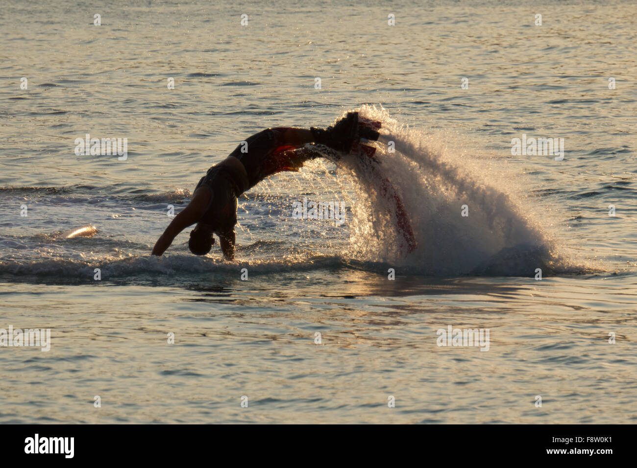 Flyboarder diving in up to his arms Stock Photo - Alamy