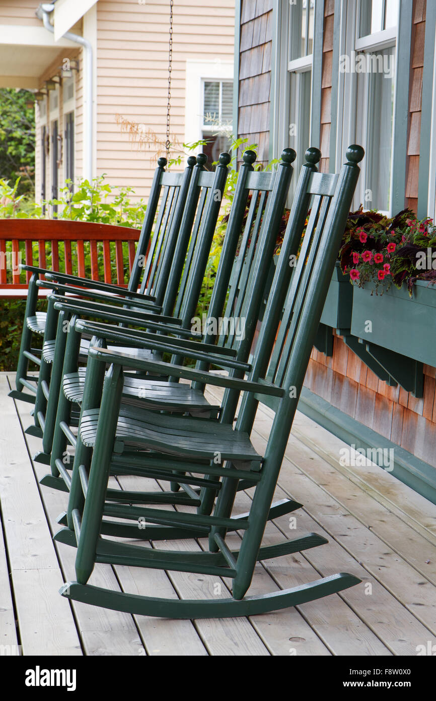 Four green rocking chairs Stock Photo - Alamy