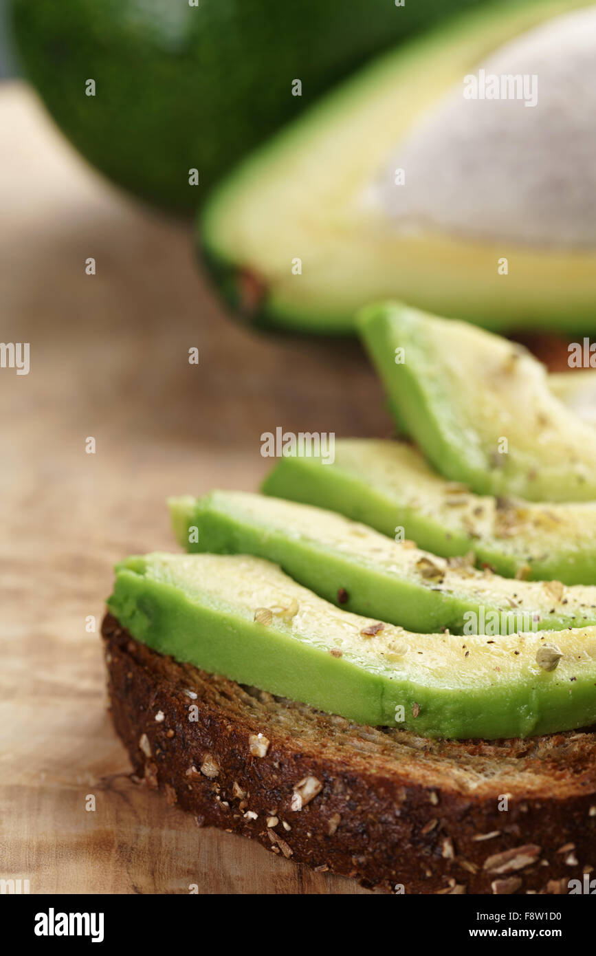 toasted rye bread with sliced avocado and herbs Stock Photo - Alamy