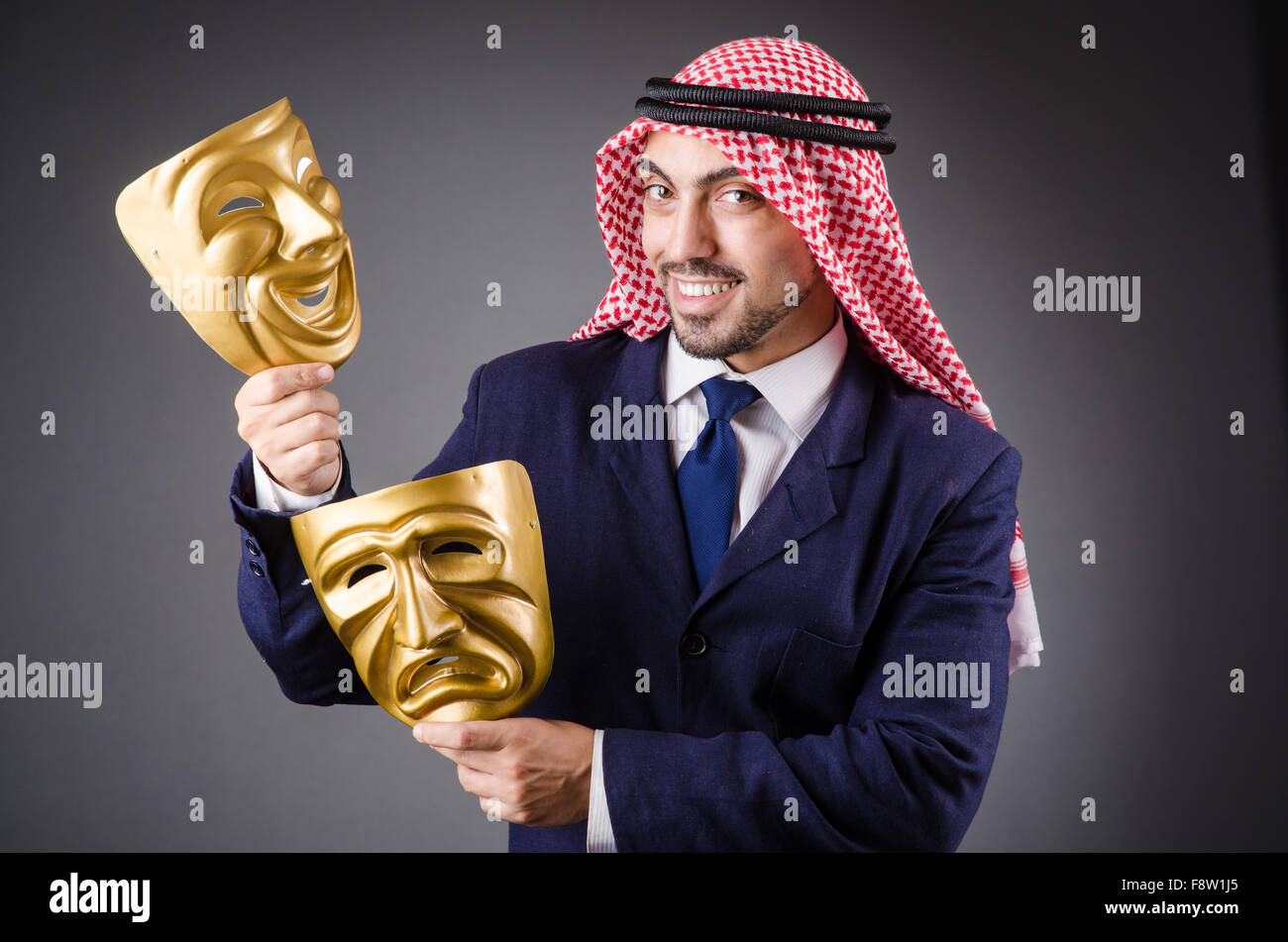 Arab with masks in dark studio Stock Photo - Alamy