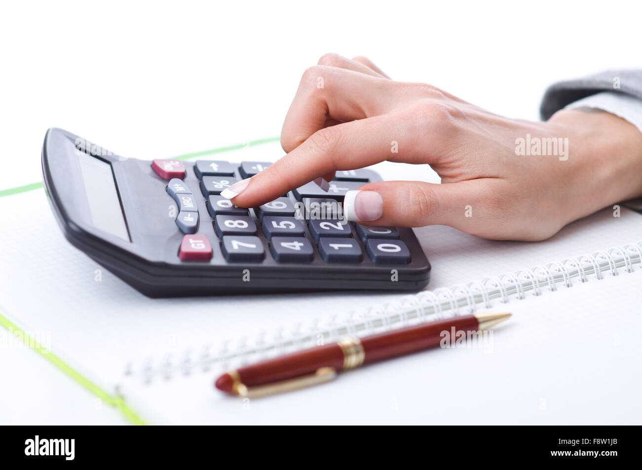 Hands working on the calculator Stock Photo - Alamy