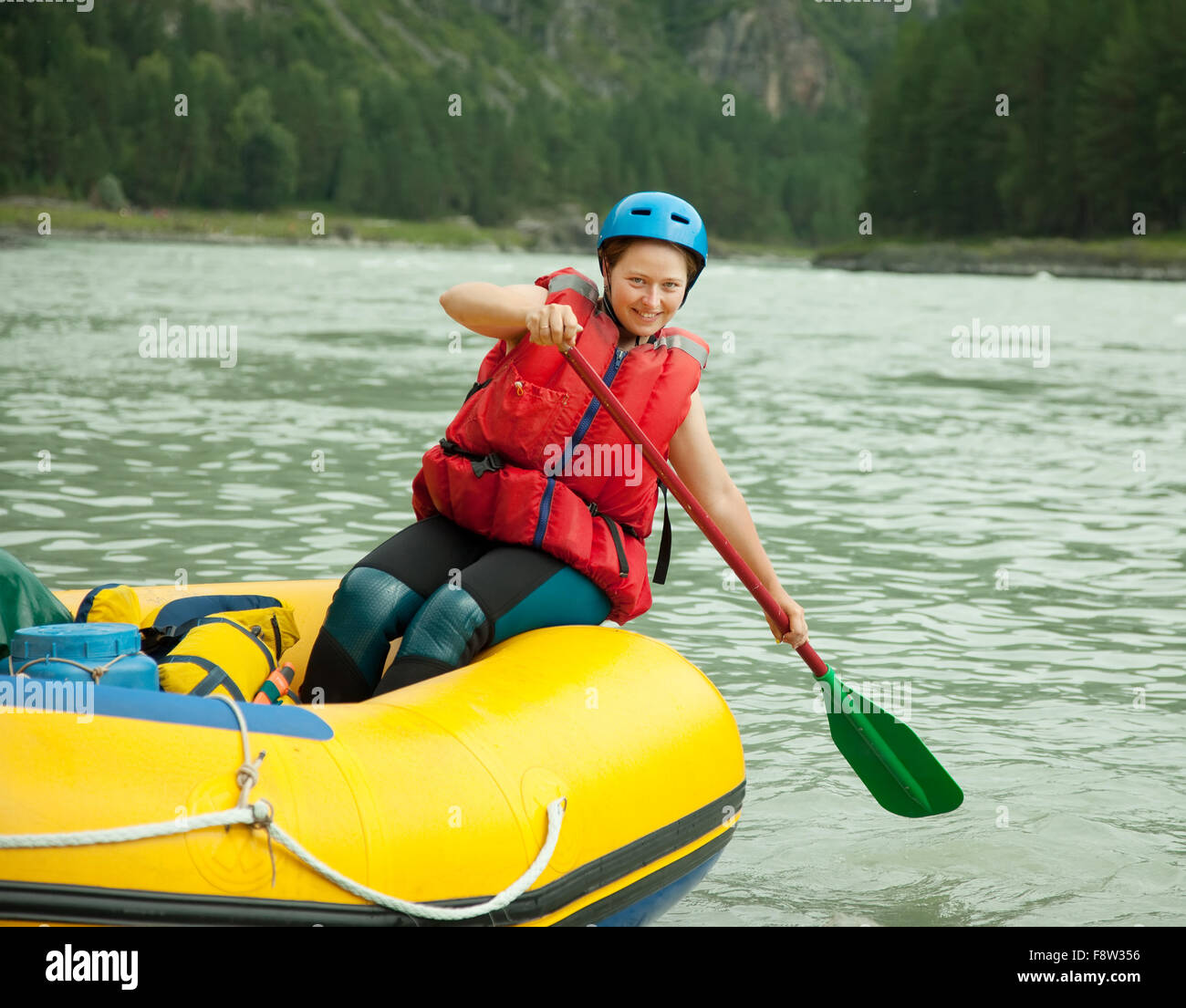 Girl with a paddle on the raft Stock Photo - Alamy