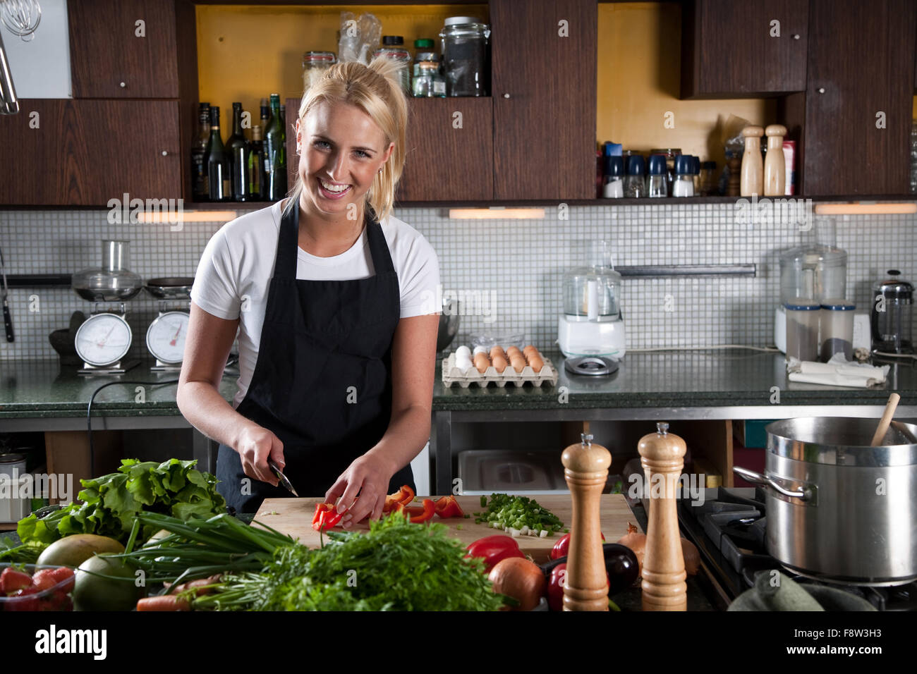 Happy female chef in the kitchen Stock Photo - Alamy