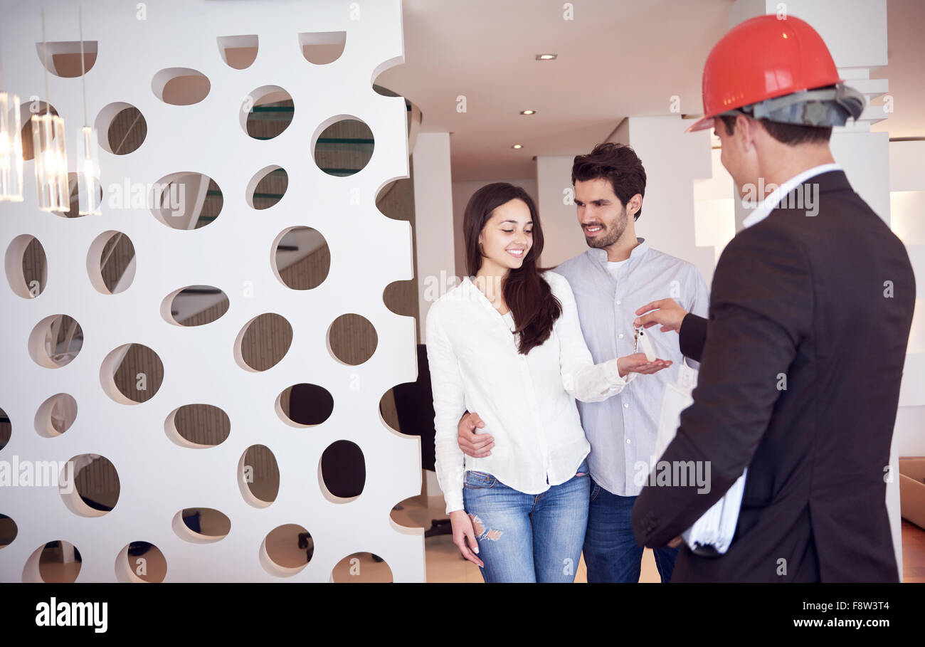 happy young family, couple buying new home with real estate agent ...