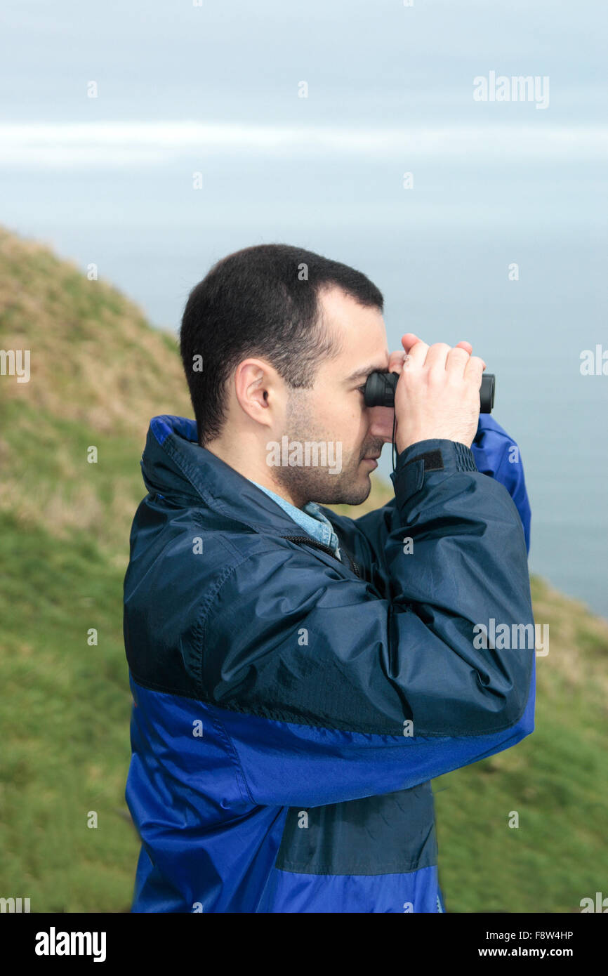 Man with binoculars Stock Photo - Alamy