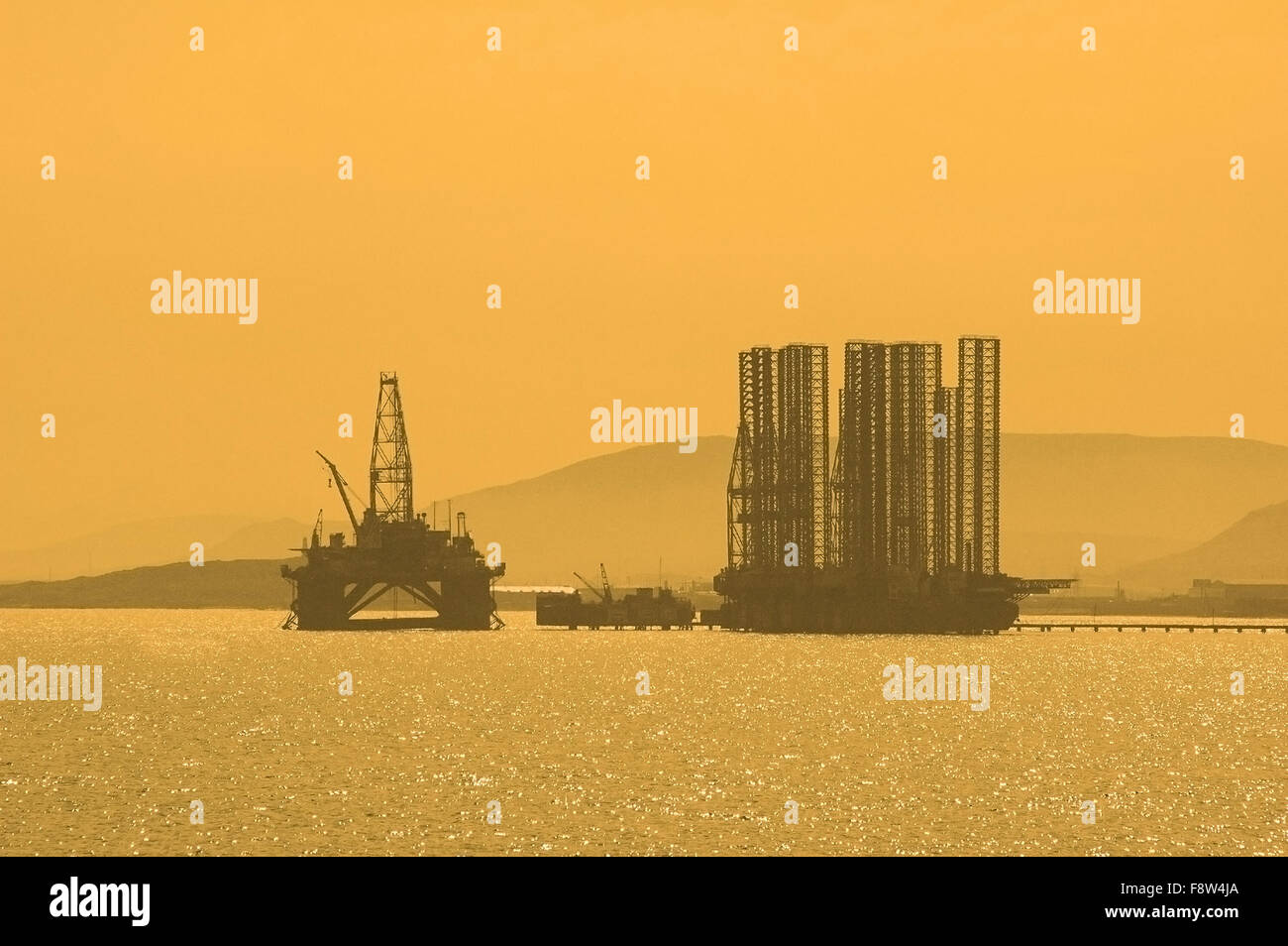 Oil rig during sunset in Baku, Azerbaijan in Caspian Sea Stock Photo ...