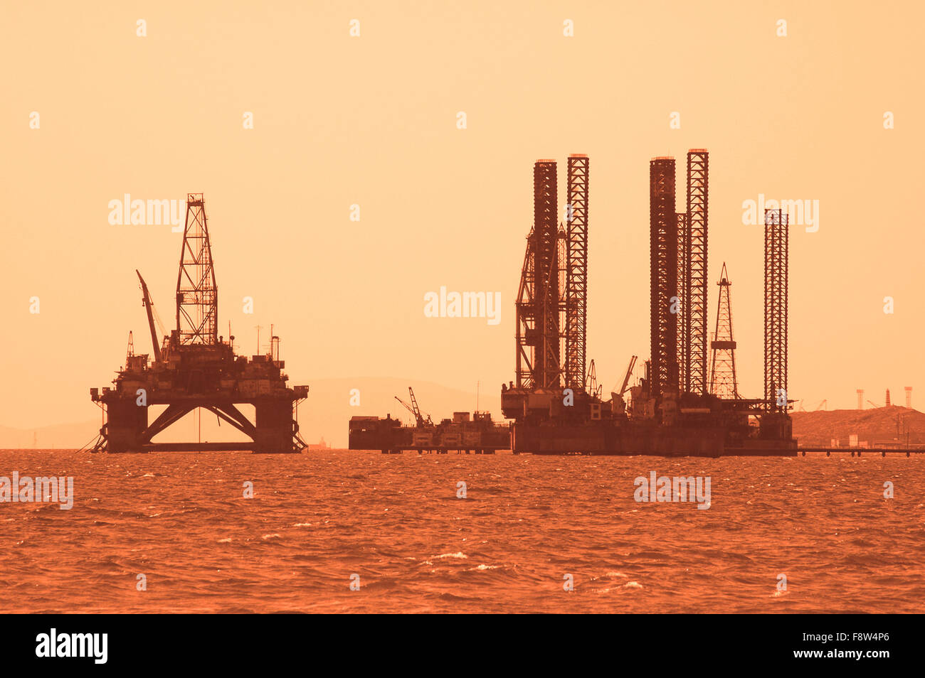 Oil rig during sunset in Baku, Azerbaijan in Caspian Sea Stock Photo ...