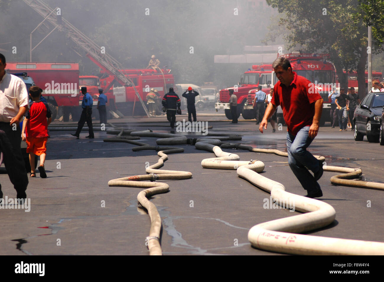 Fire hoses stretching across the street during fire Stock Photo - Alamy
