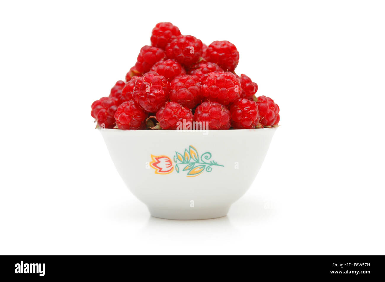 Bowl full of raspberries isolated on white Stock Photo - Alamy